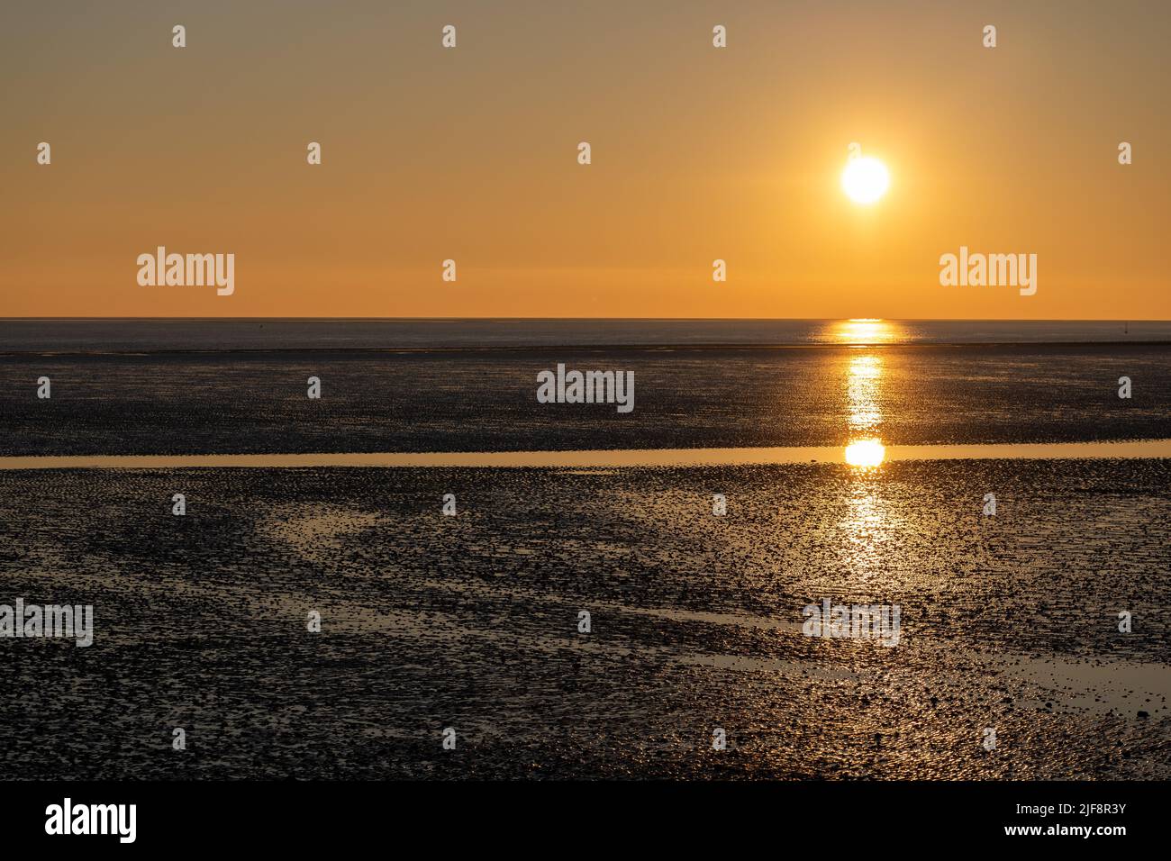 A breathtaking scene of sunset clean sky with a reflection on a sea ...