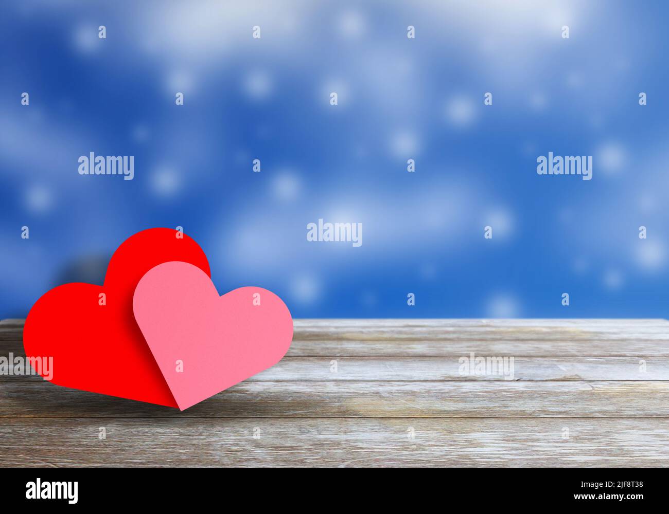 Red and pink heart on wood panel table with bokeh light as background ...