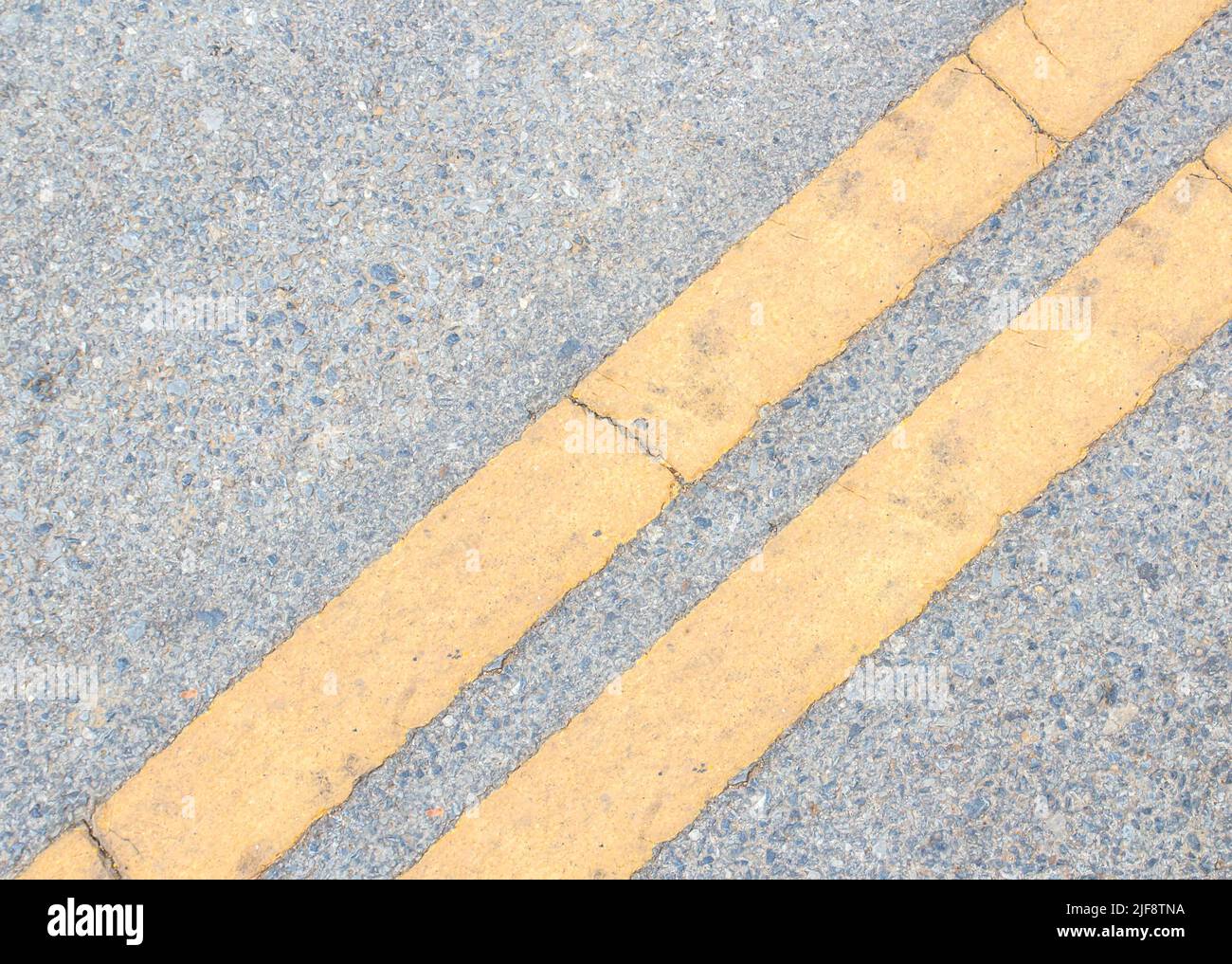Close up yellow line on the road texture Stock Photo - Alamy