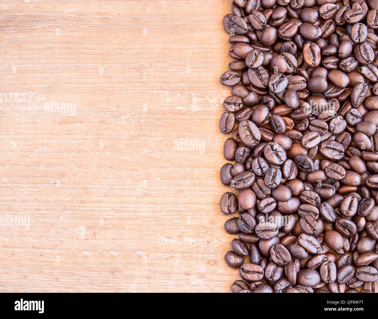 Coffee beans on wooden table background for any design Stock Photo - Alamy