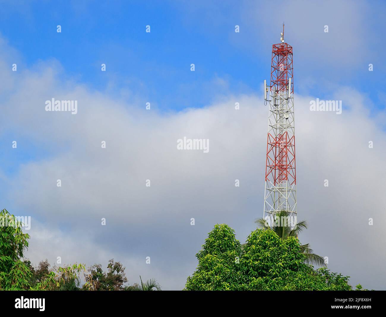 Antenna and cellular tower in blue sky background Stock Photo - Alamy