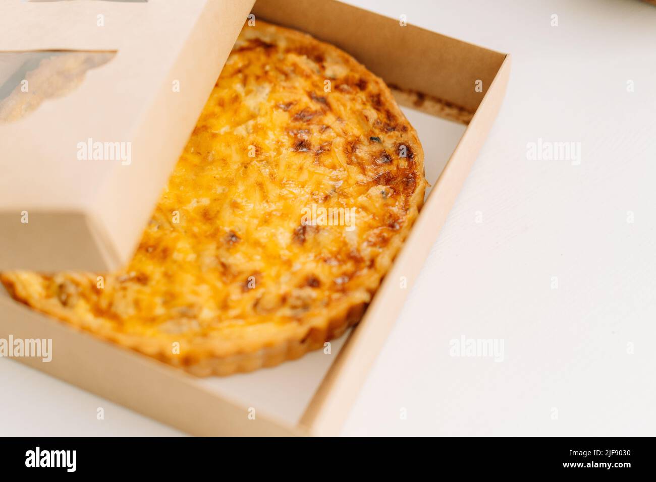 Pie with red fish in a box on a white table Stock Photo - Alamy