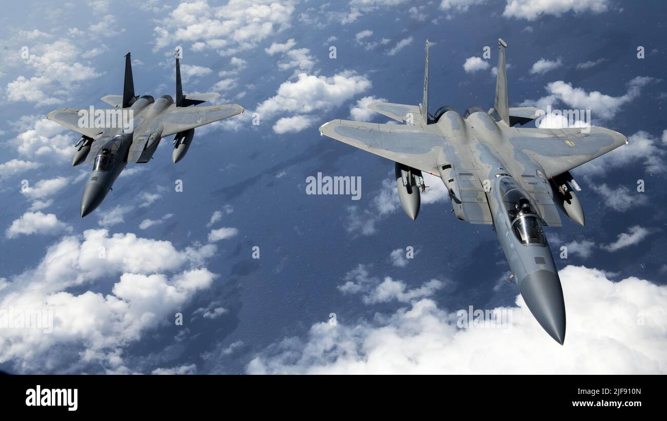 Two U.S. Air National Guard F-15C Eagles from the 159th Fighter Wing fly in formation with a KC ...