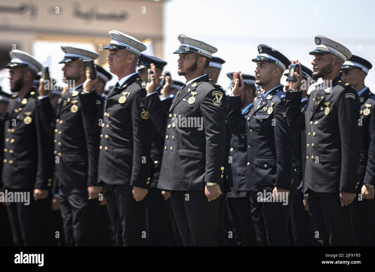 Members of the Palestinian police queue during a graduation ceremony at ...