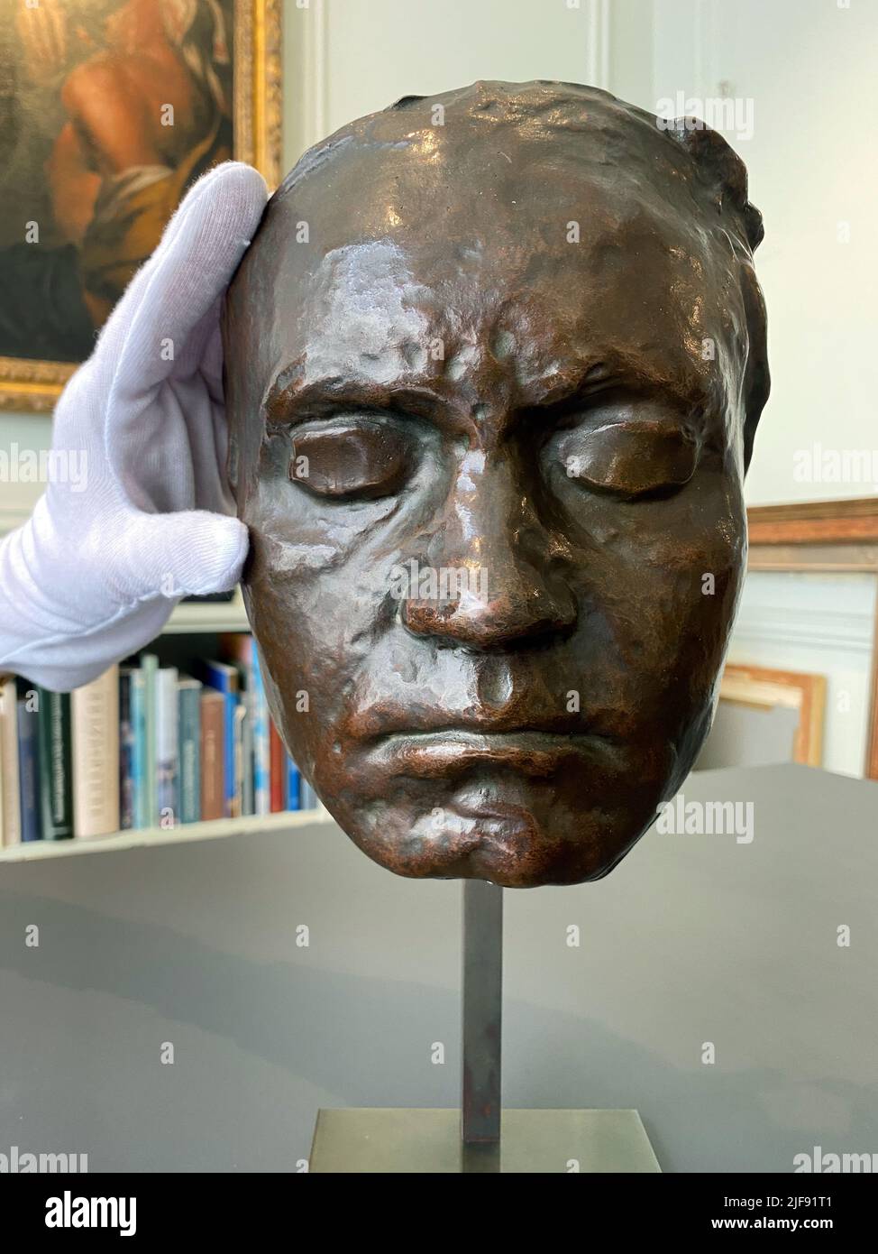 London, UK. 30th June, 2022. A woman displays a bronze cast of a living ...