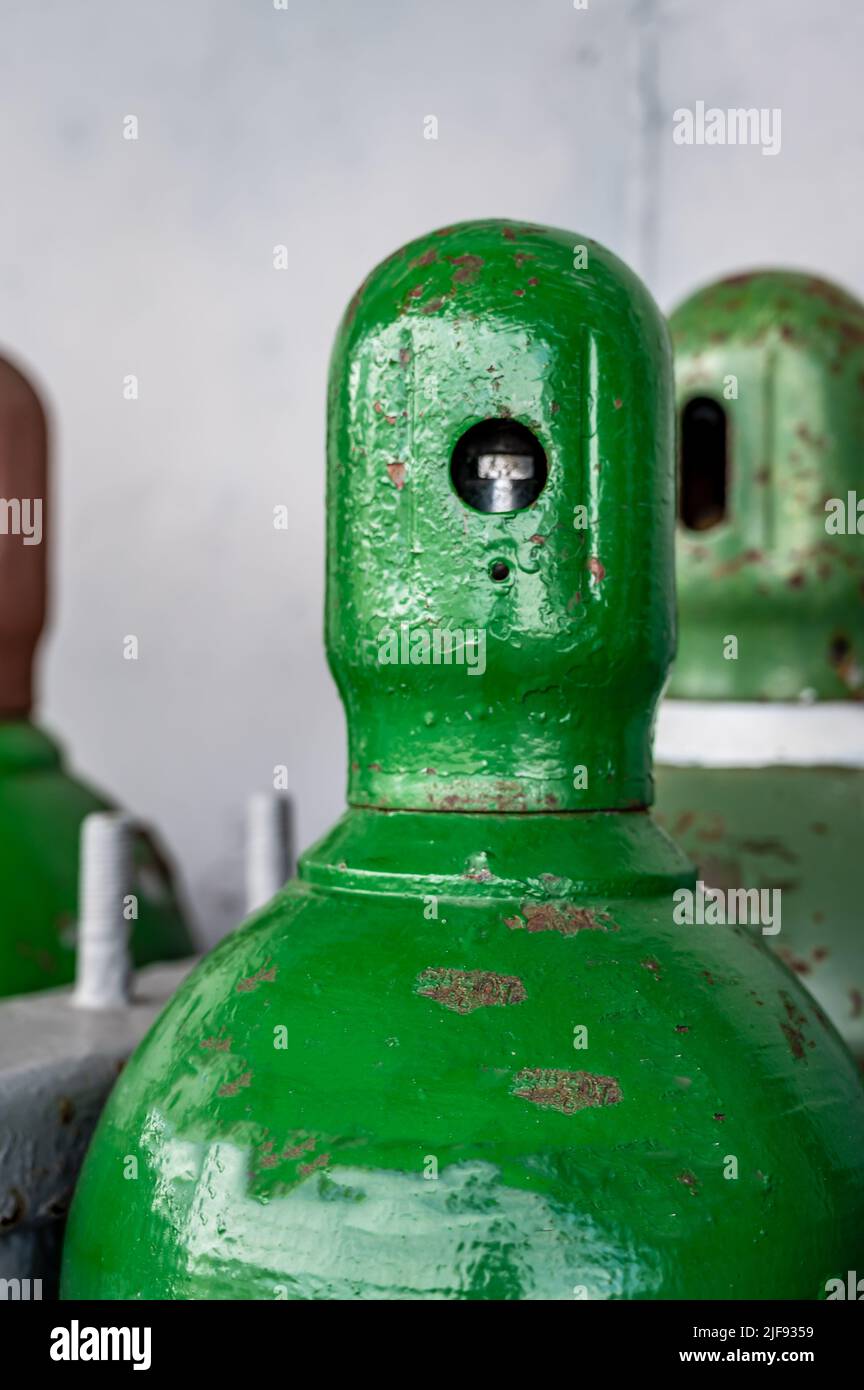 Compressed gas cylinders being stored vertically secured by a metal ...