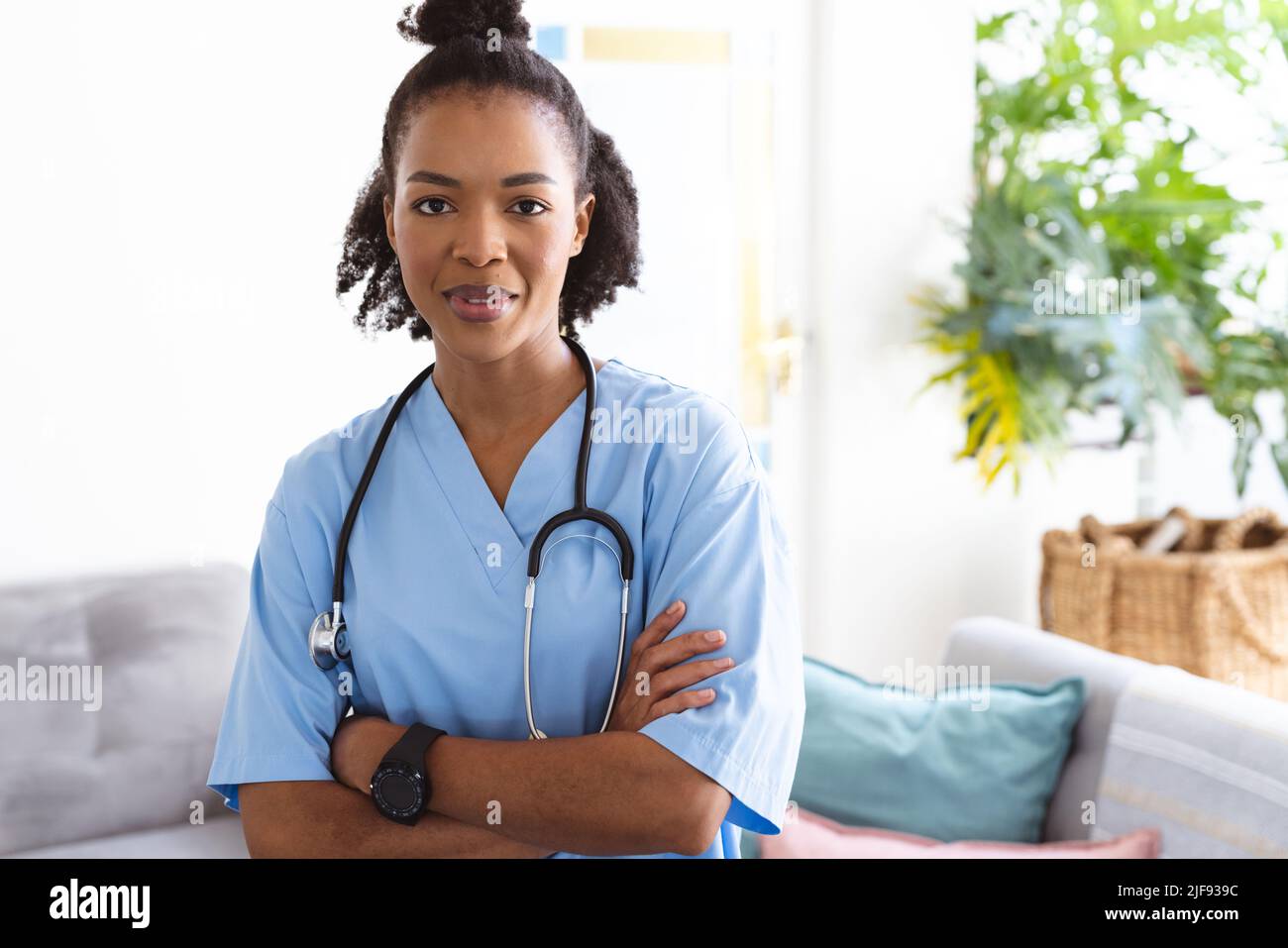 Portrait of confident african american female doctor with arms crossed ...