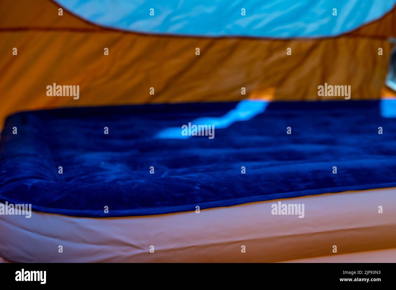 Selective focus of an inflatable air mattress on the floor of a tent ...
