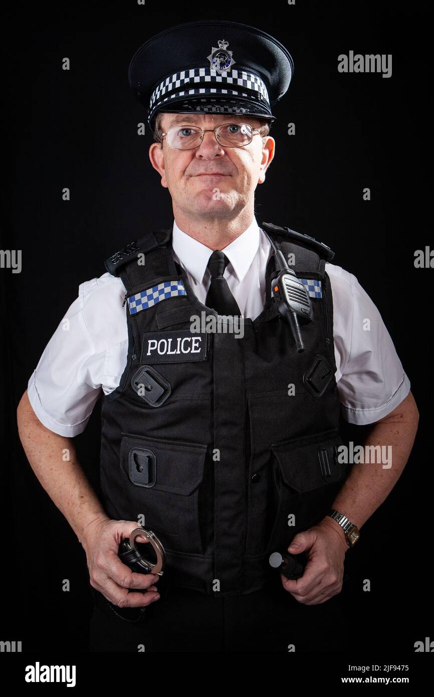 A UK uniformed policeman alert and prepared for duty. Part of a series ...