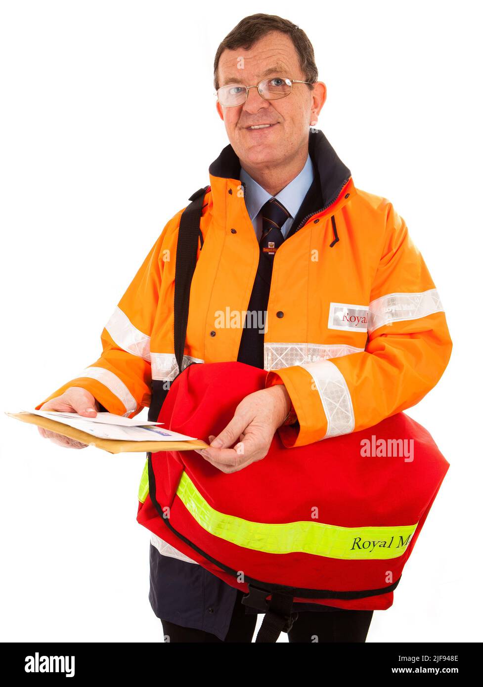 British Postman, delivering the mail. A UK uniformed postal worker with ...
