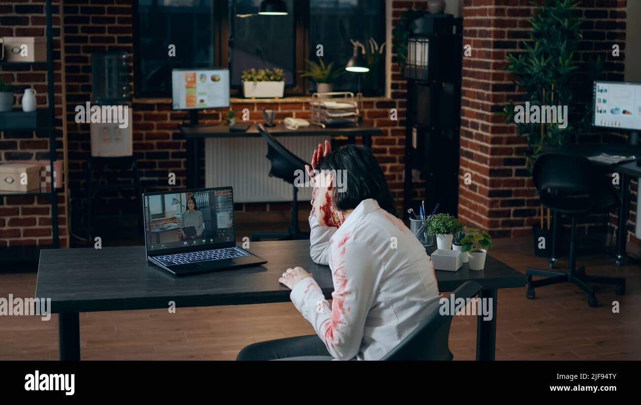 Angry creepy office zombie sitting at desk while gesturing angrily at ...