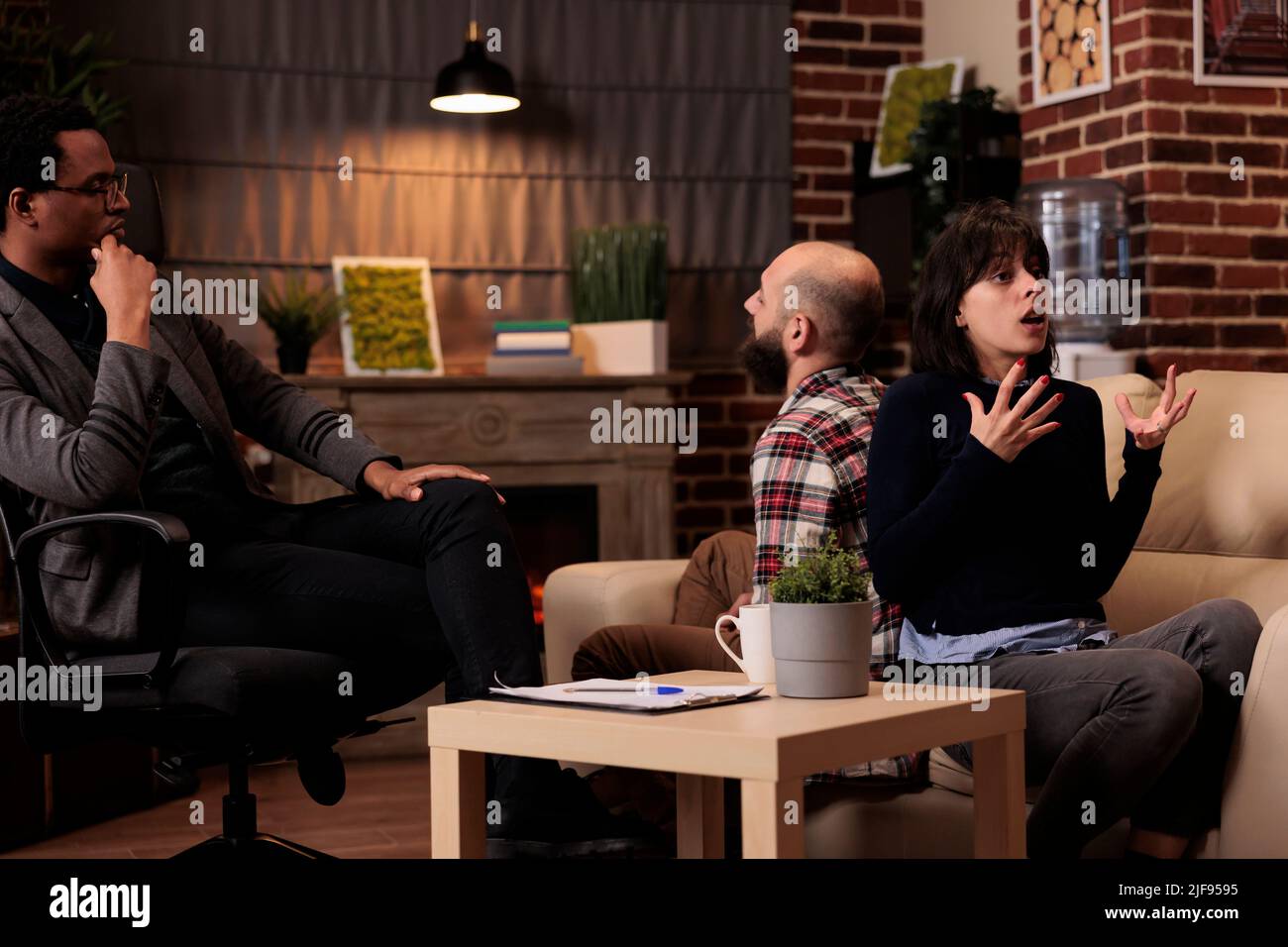 Husband and wife fighting at couple therapy session with counselor ...