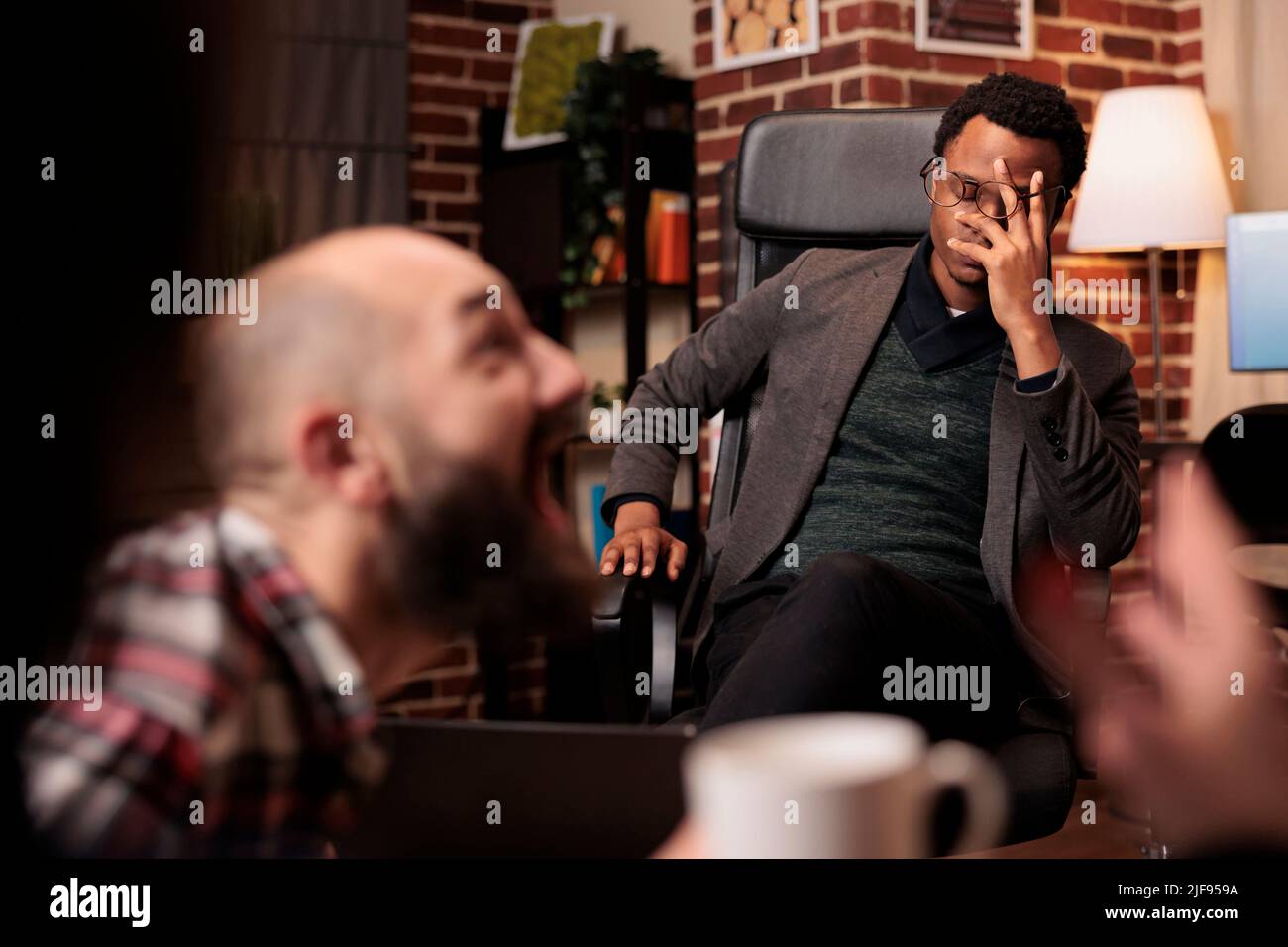 Stressed tired psychologist listening to couple fighting at therapy ...