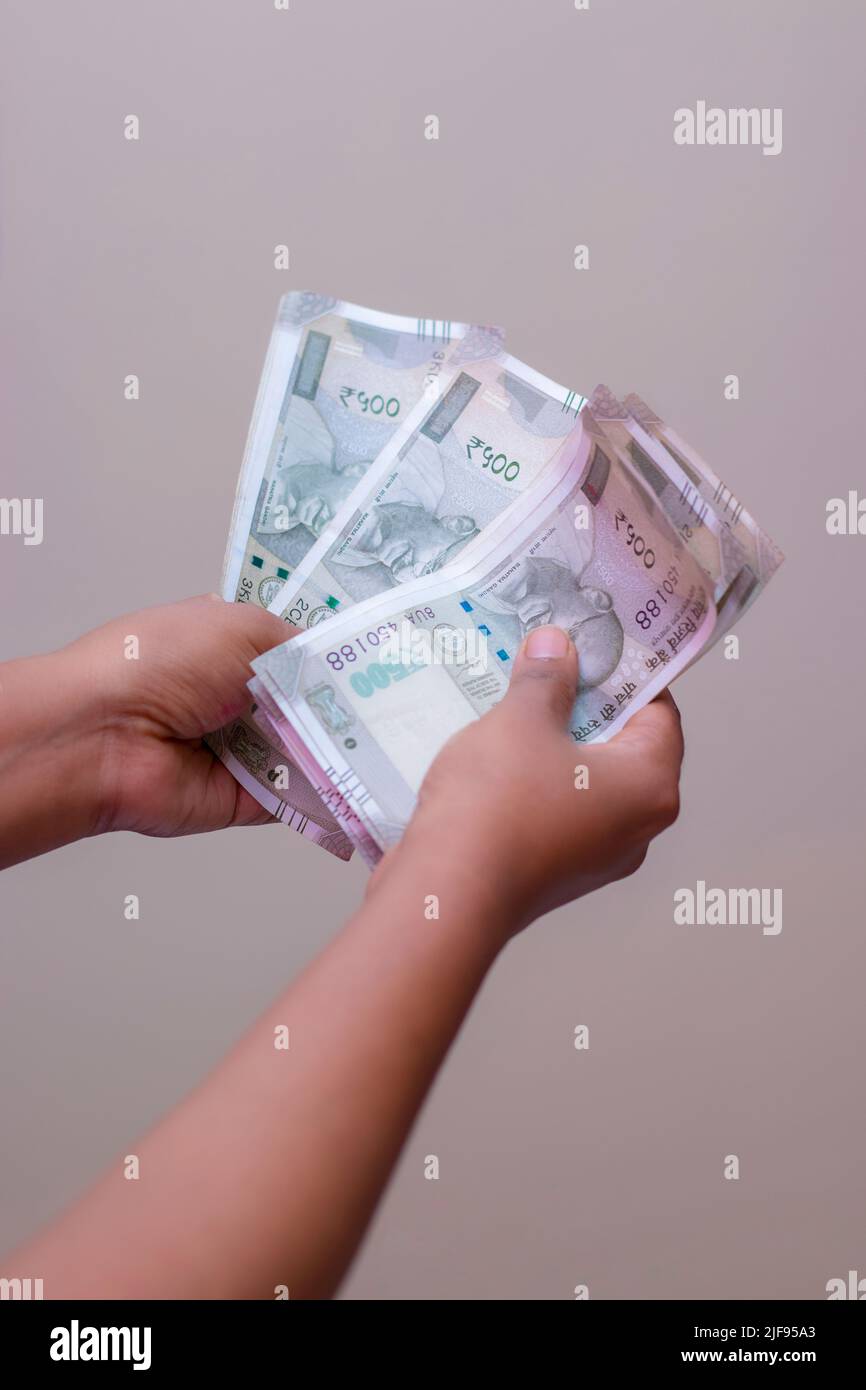 selective focus counting Indian five hundred rupees currency notes ...