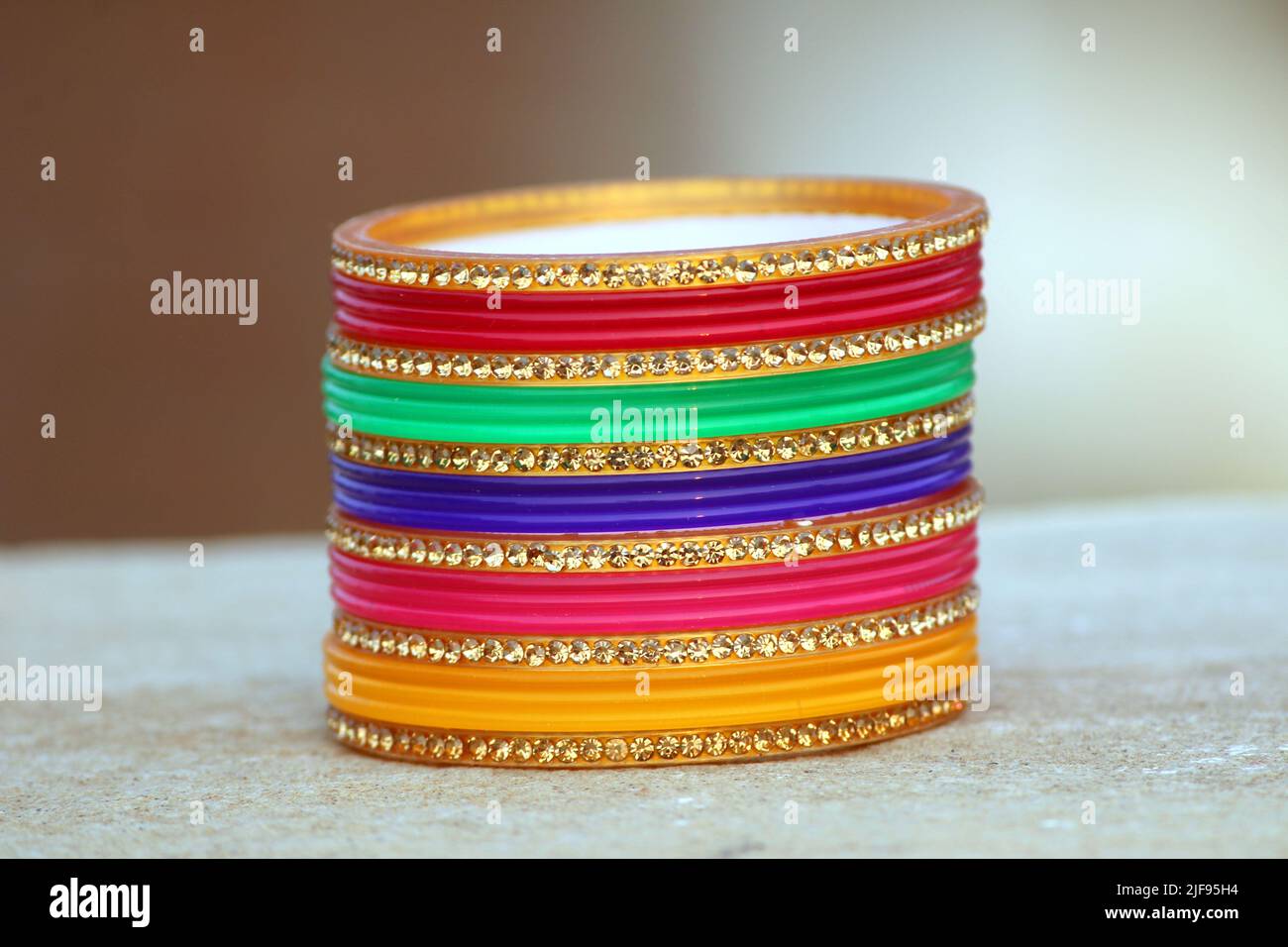 some colorful bangles put on stone Stock Photo - Alamy