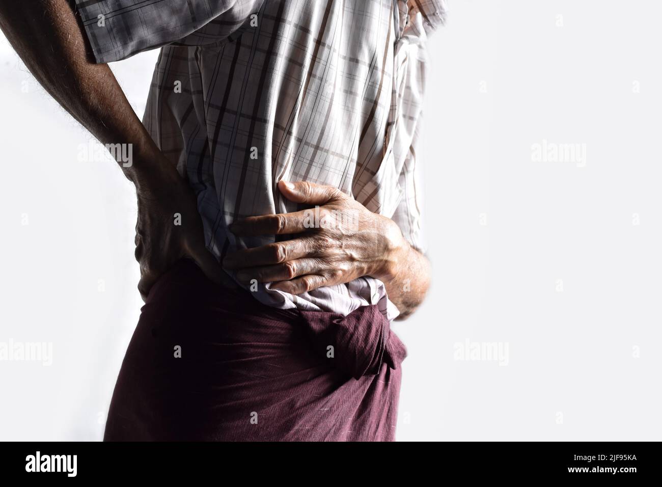 Asian elder man suffering from right loin pain. It can be caused by ...