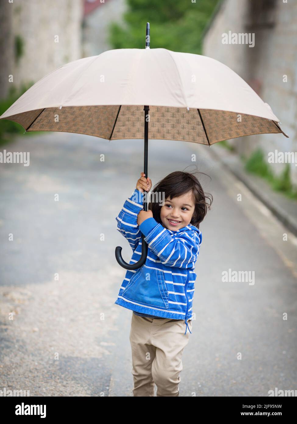 Little eastern handsome baby boy playing with umbrella outdoor Stock ...