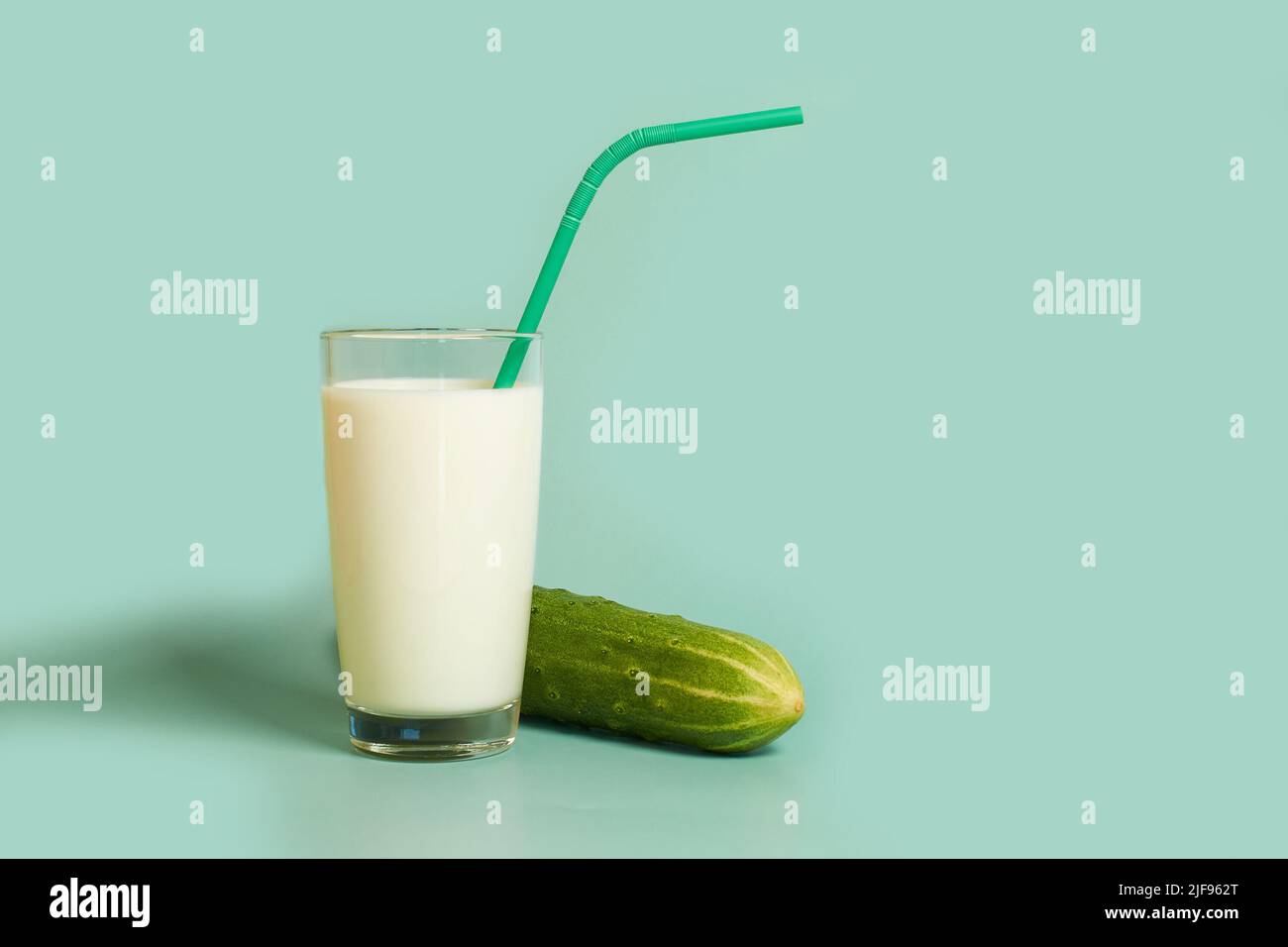 Glass with milk, plastic tube and cucumber Stock Photo - Alamy
