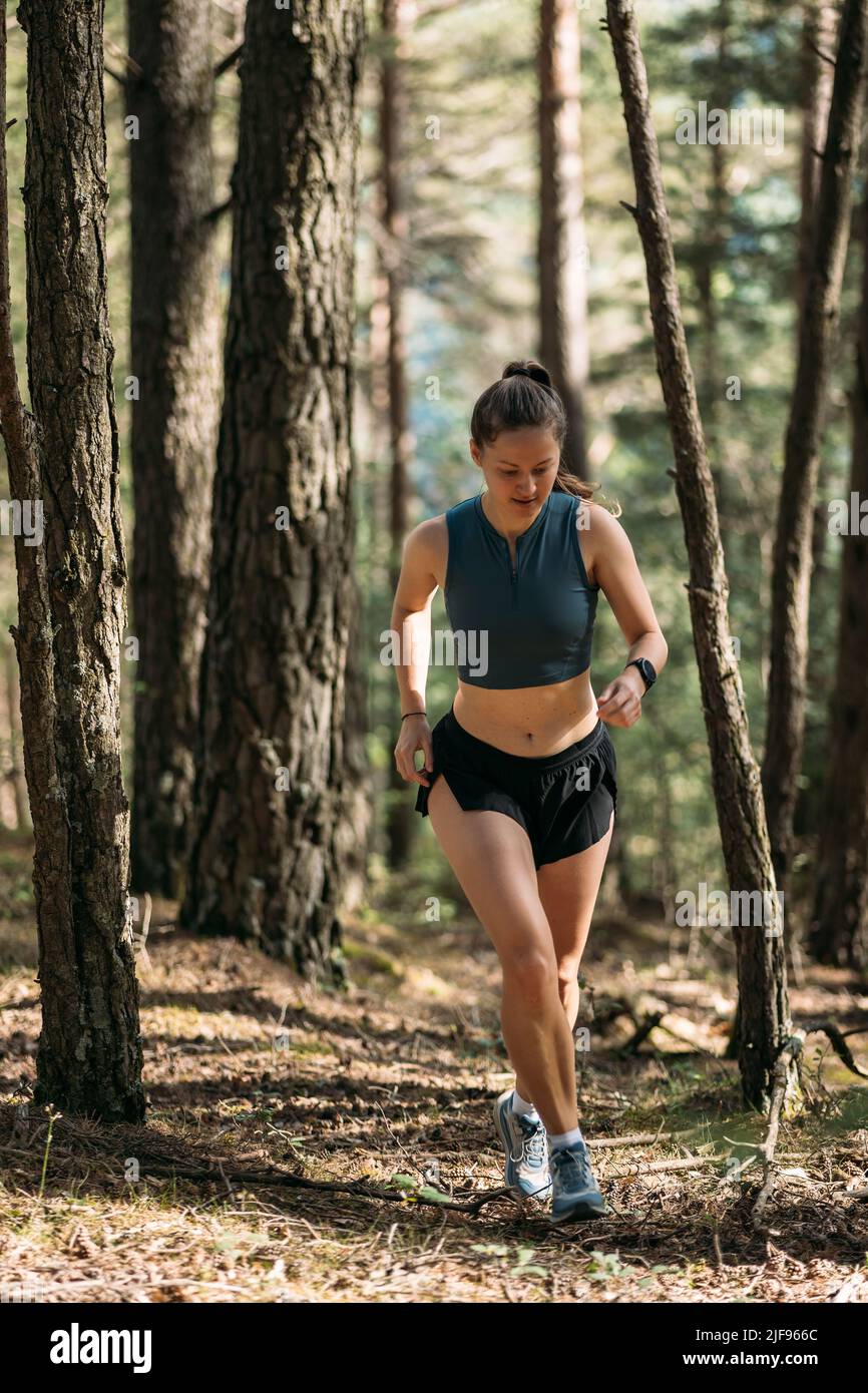 Young woman in sportswear enjoy trail running and working out in the ...