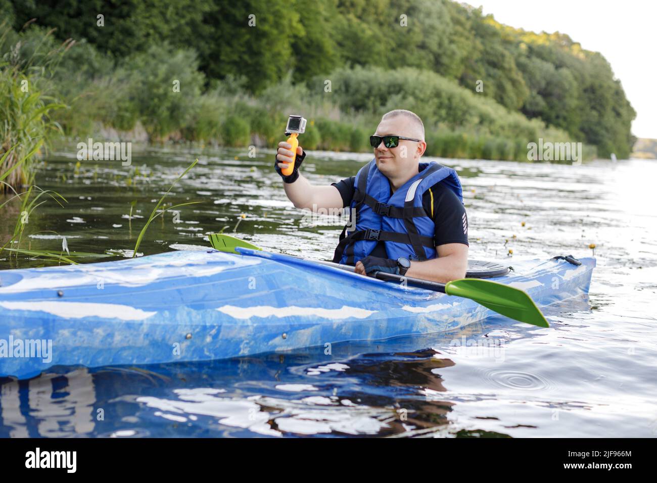 Kayaking on the river. Young Caucasian man sitting in a kayak and ...