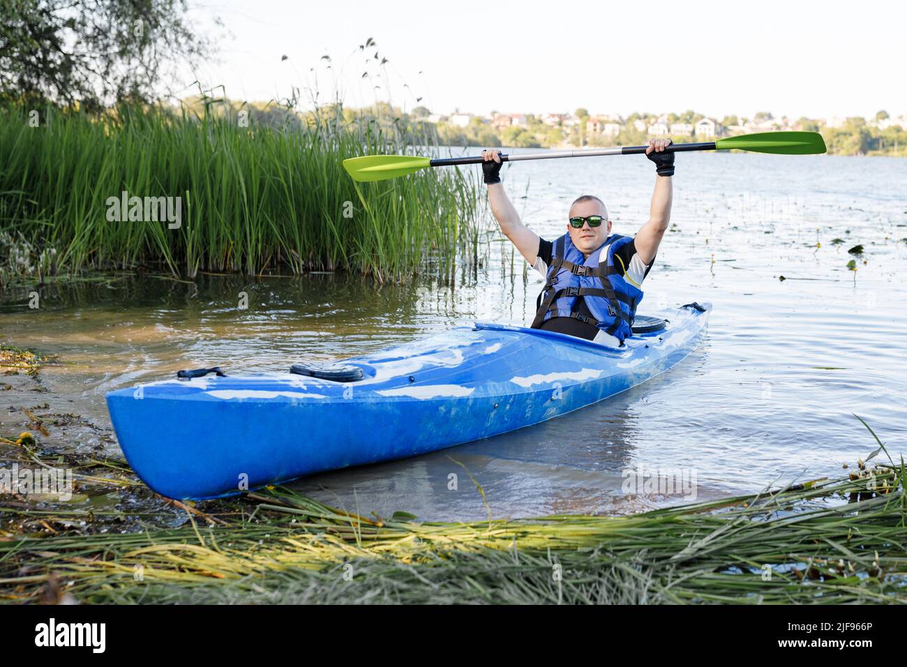 Kayaking on the river. Adult caucasian man is sitting in a kayak and ...