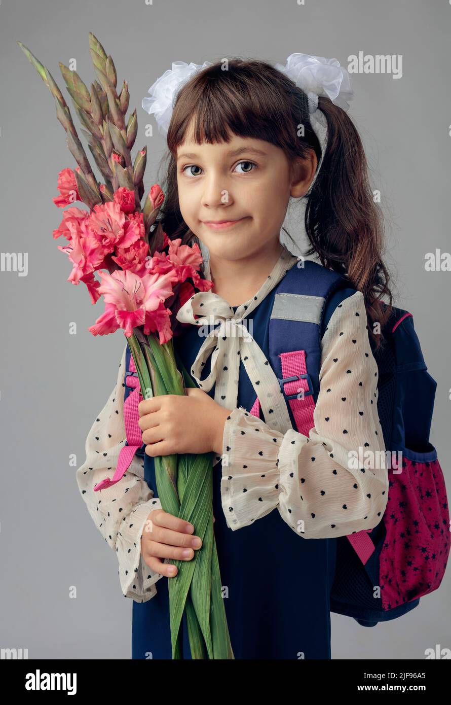 Portrait of a girl in a primary school uniform. A first-grader with a ...