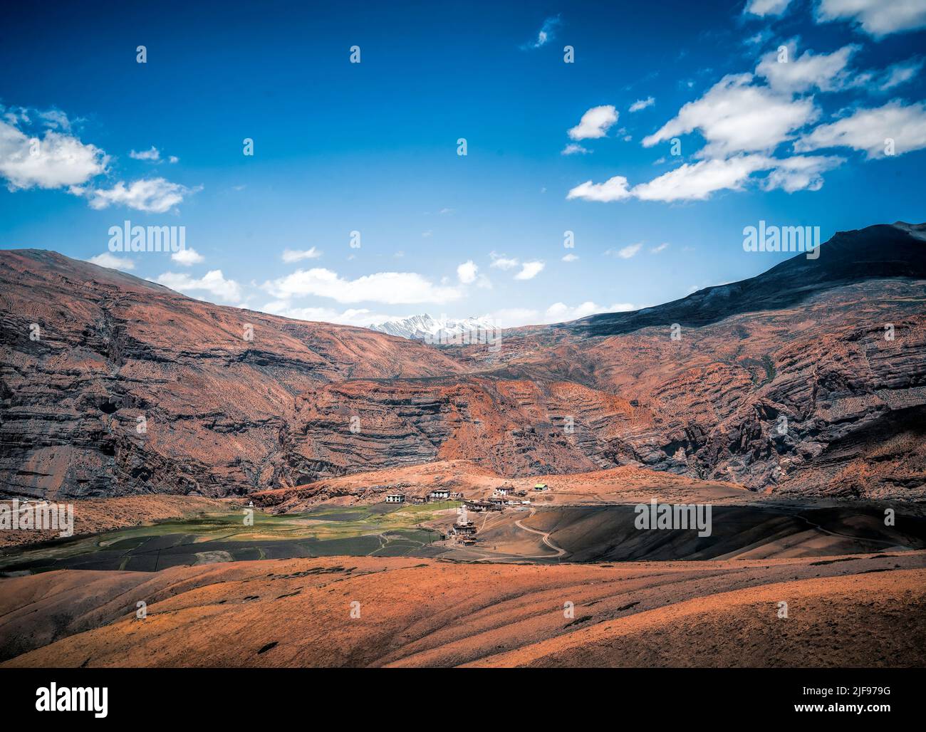 An aerial view of valley between red arid rocks on blur sky background ...