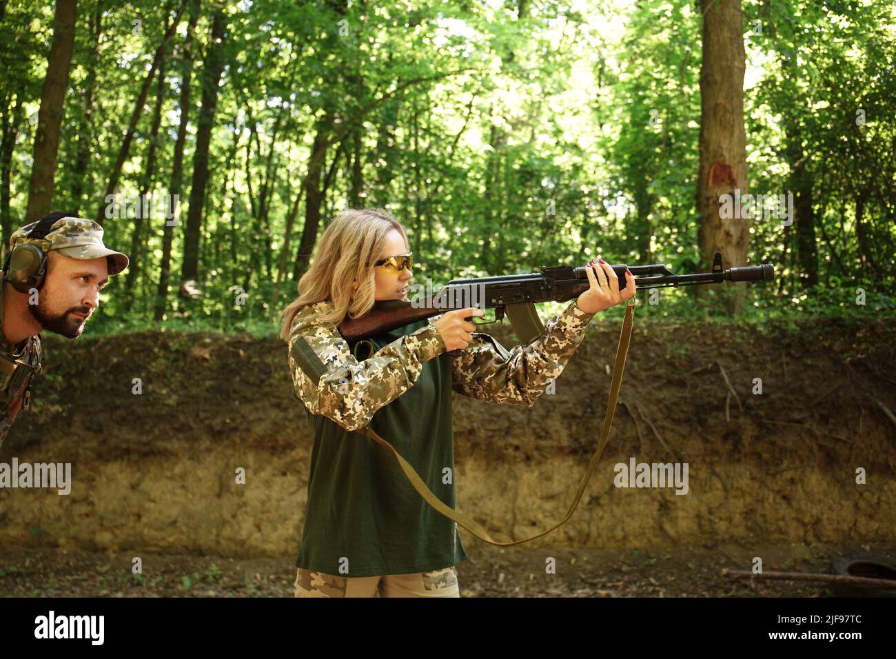 A Ukrainian woman is training to shoot an Akm machine gun during ...