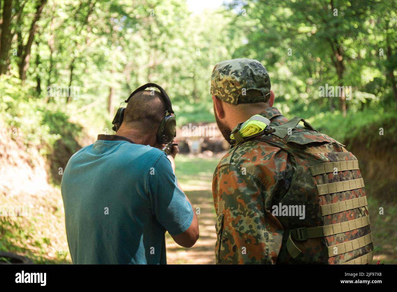 A Ukrainian civilian man is training to shoot an Akm machine gun during ...
