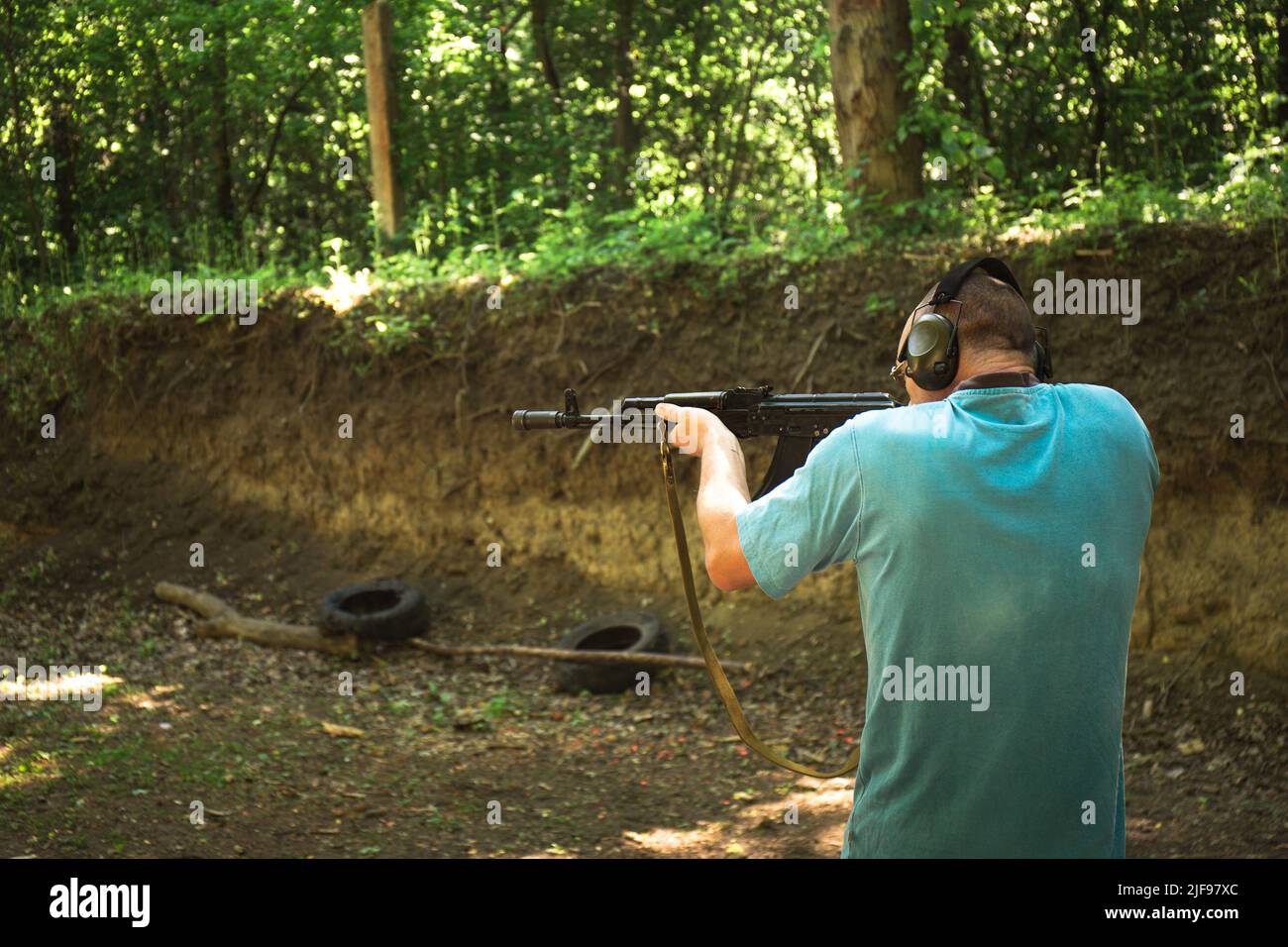 A Ukrainian civilian man is training to shoot an Akm machine gun during ...