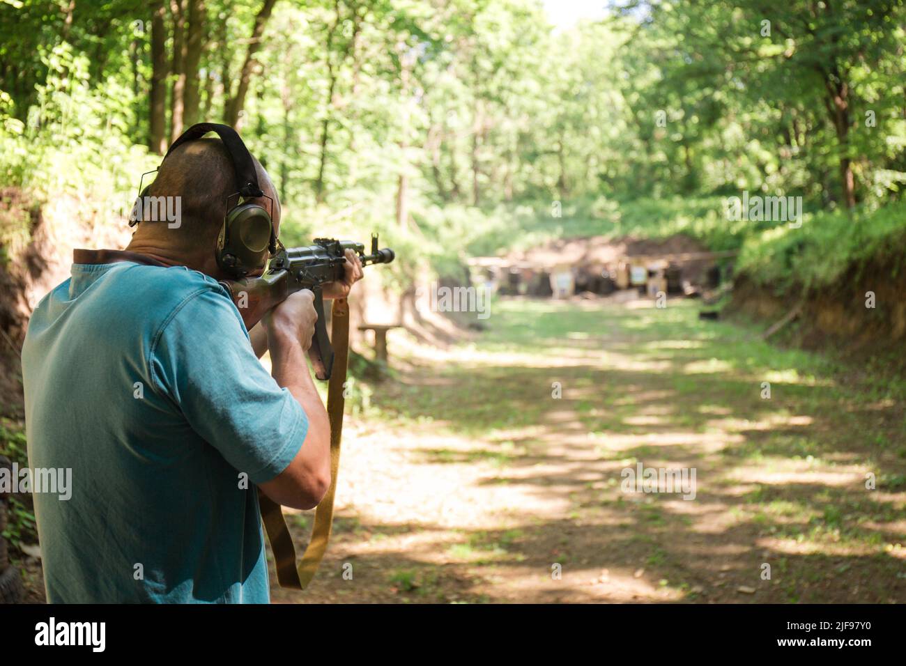 A Ukrainian civilian man is training to shoot an Akm machine gun during ...