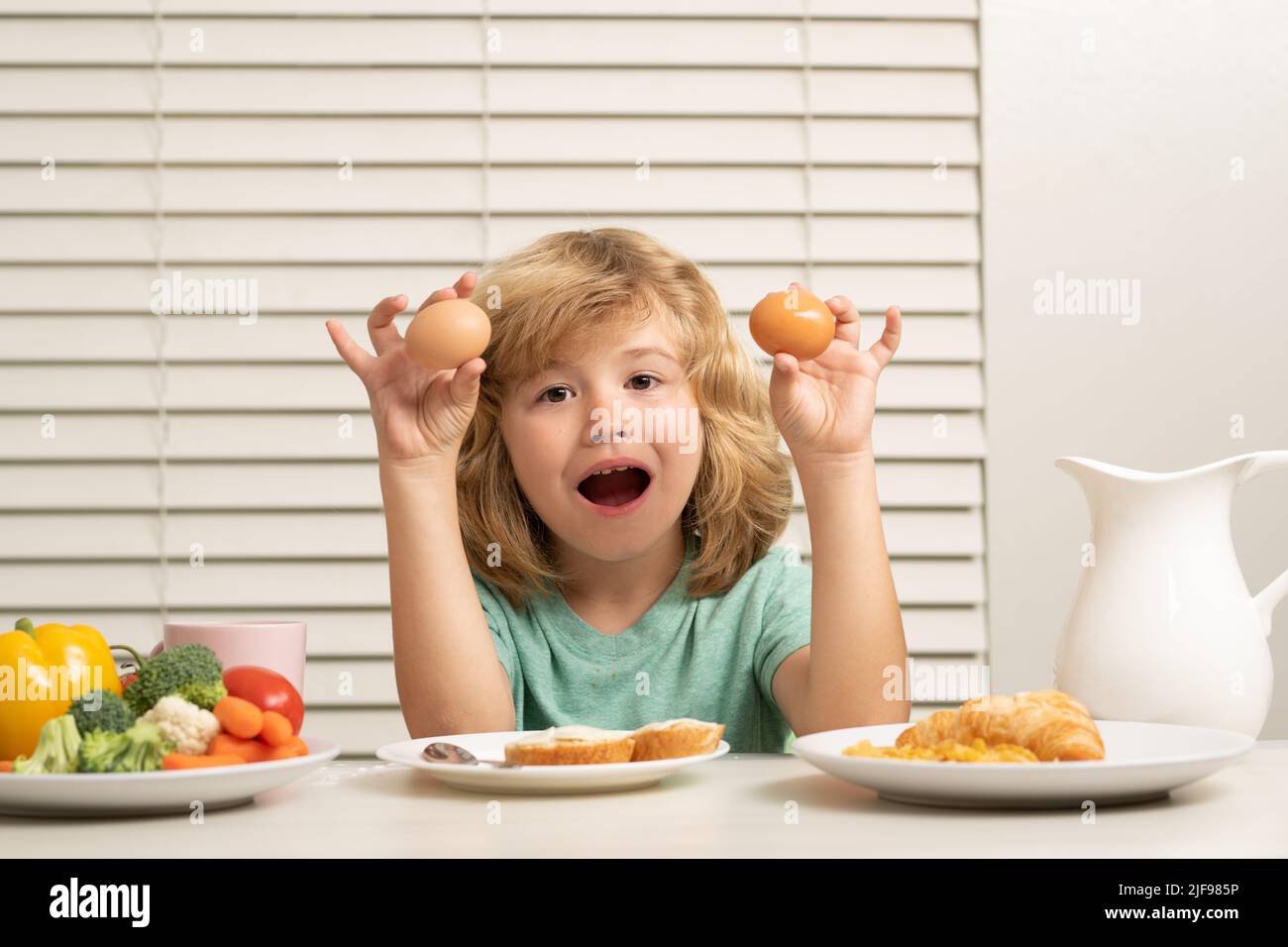 Kid eating egg. Little child boy having healthy breakfast. Children ...