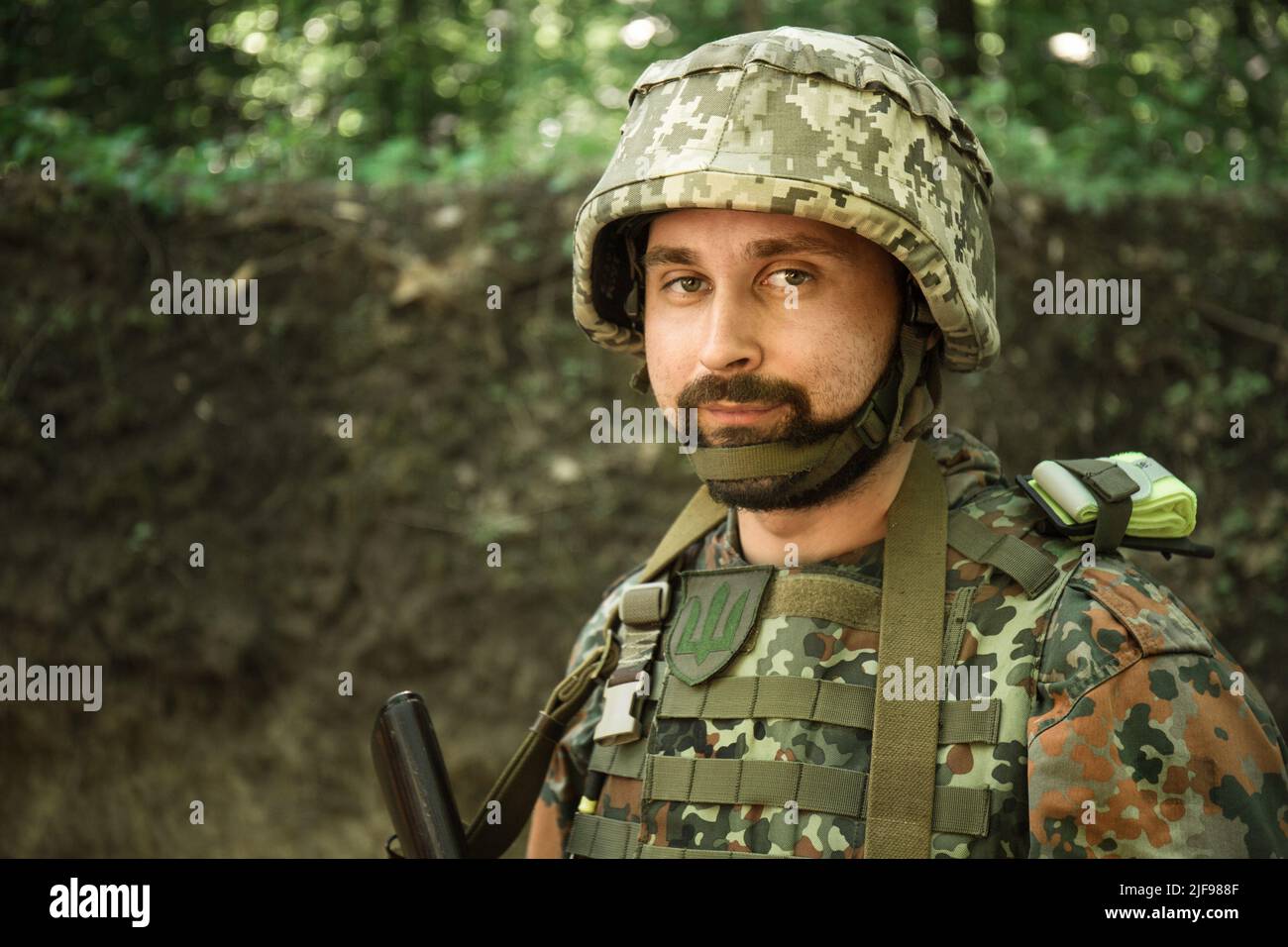 Portrait of a Ukrainian military man with a Kalashnikov assault rifle ...