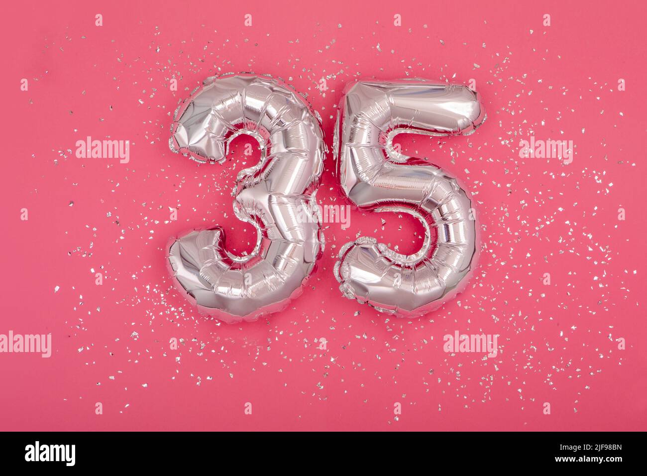 Silver balloon shape of number thirty five 35 pink background Stock ...