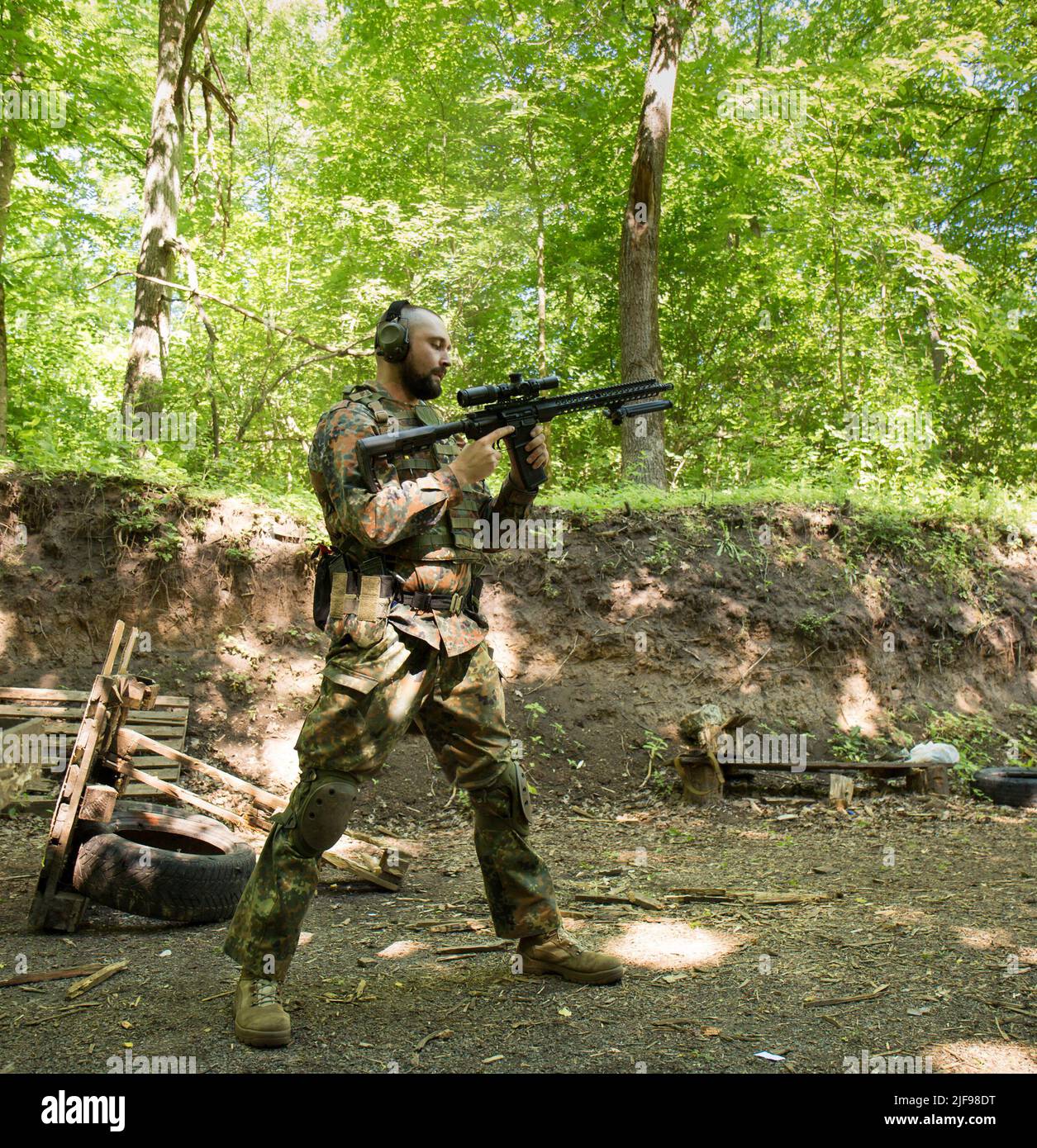Ukrainian defender with a machine gun Ar-15 on the landfill Stock Photo ...