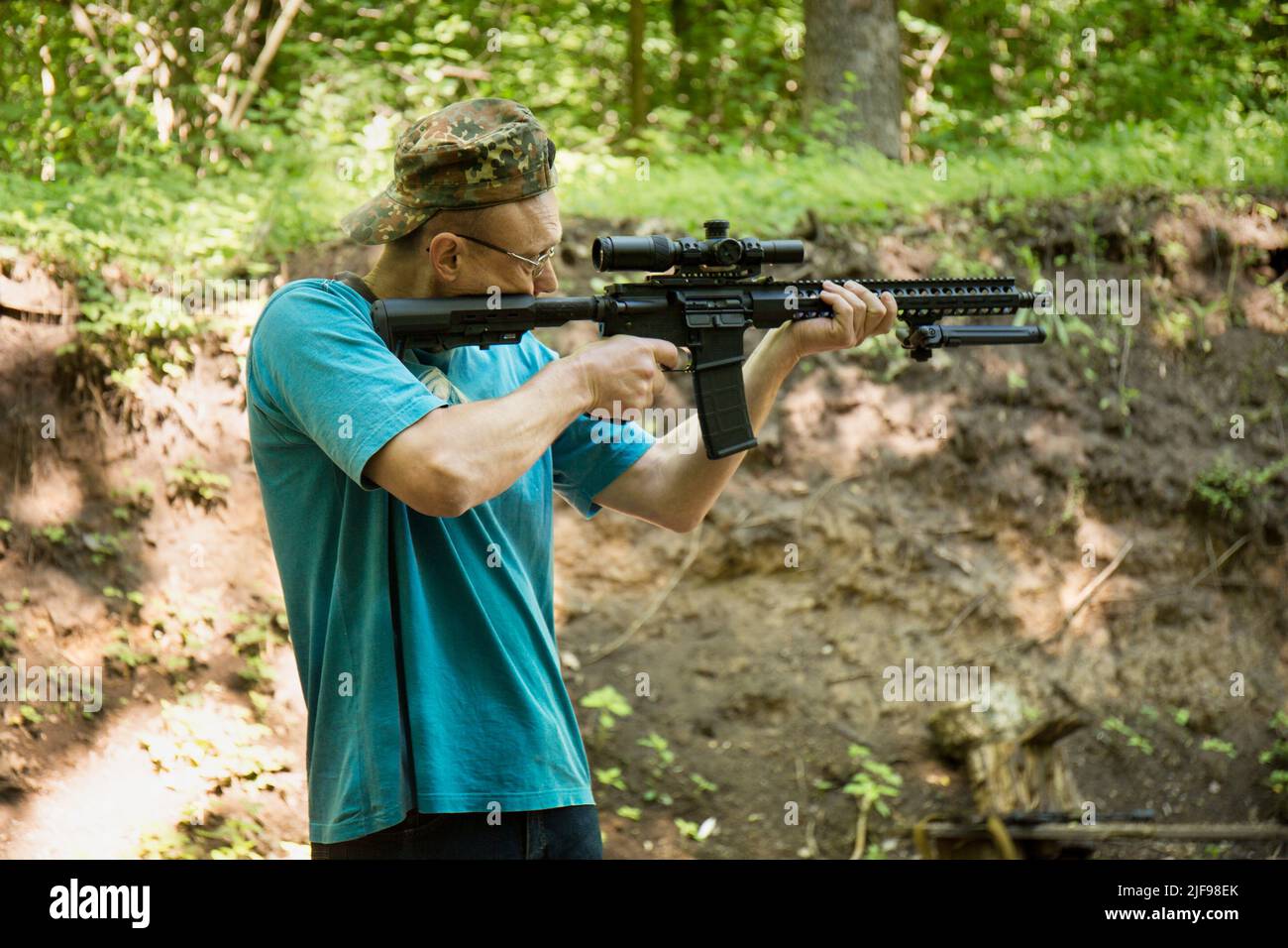A Ukrainian civilian man is training to shoot an machine gun Ar-15 ...