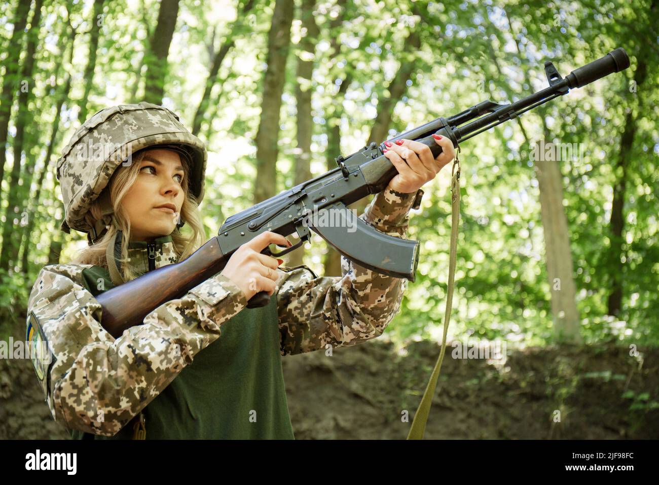 Portrait of a Ukrainian military woman with with a Kalashnikov assault ...