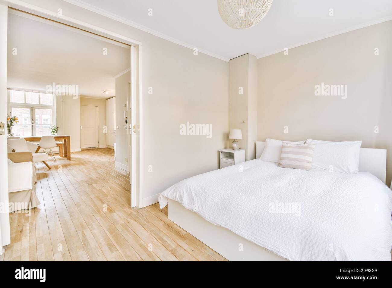 Home interior design of bedroom with bed and wooden wardrobe placed in ...