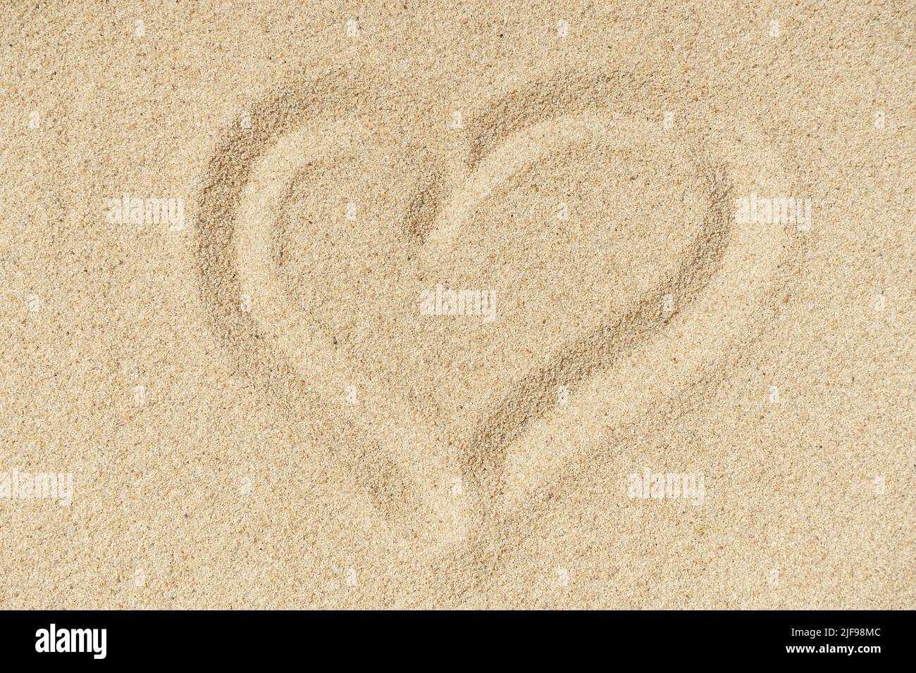 Heart sand beach texture background. Light hot sand on the sea coast in ...
