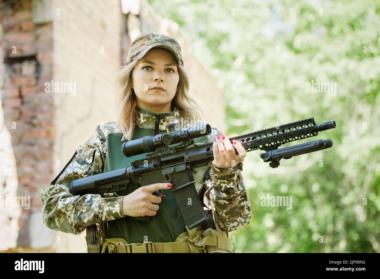 Portrait of a Ukrainian military woman with a assault rifle Ar-15 in ...