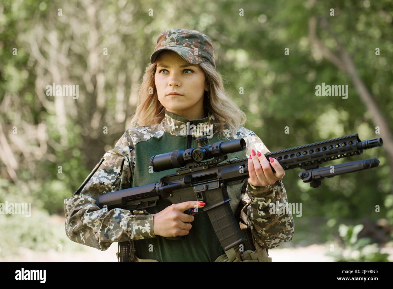 Portrait of a Ukrainian military woman with a assault rifle Ar-15 in ...
