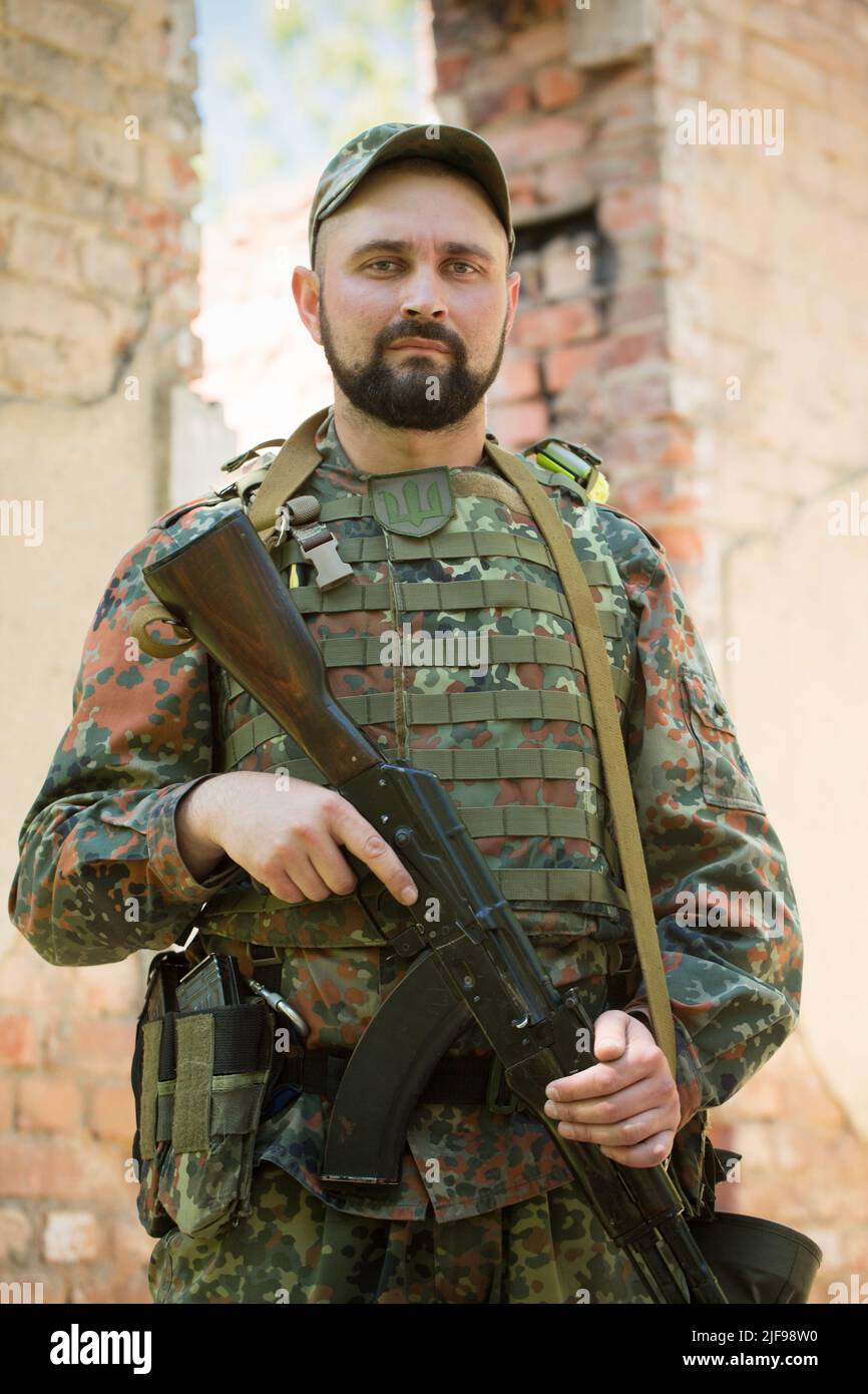 Portrait of a Ukrainian military man with a Kalashnikov assault rifle ...