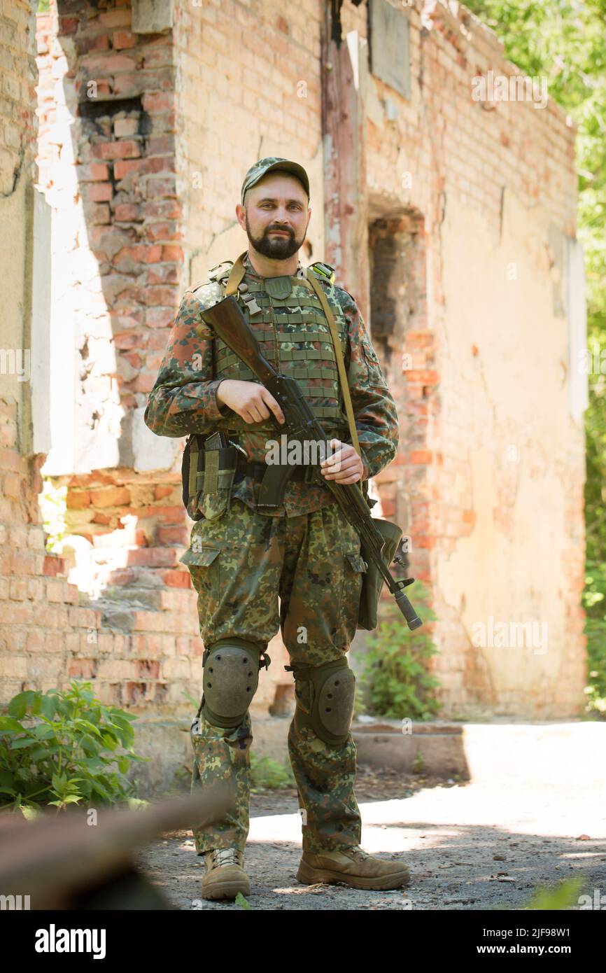 Portrait of a Ukrainian military man with a Kalashnikov assault rifle ...