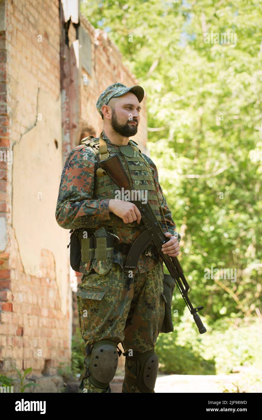 Portrait of a Ukrainian military man with a Kalashnikov assault rifle ...