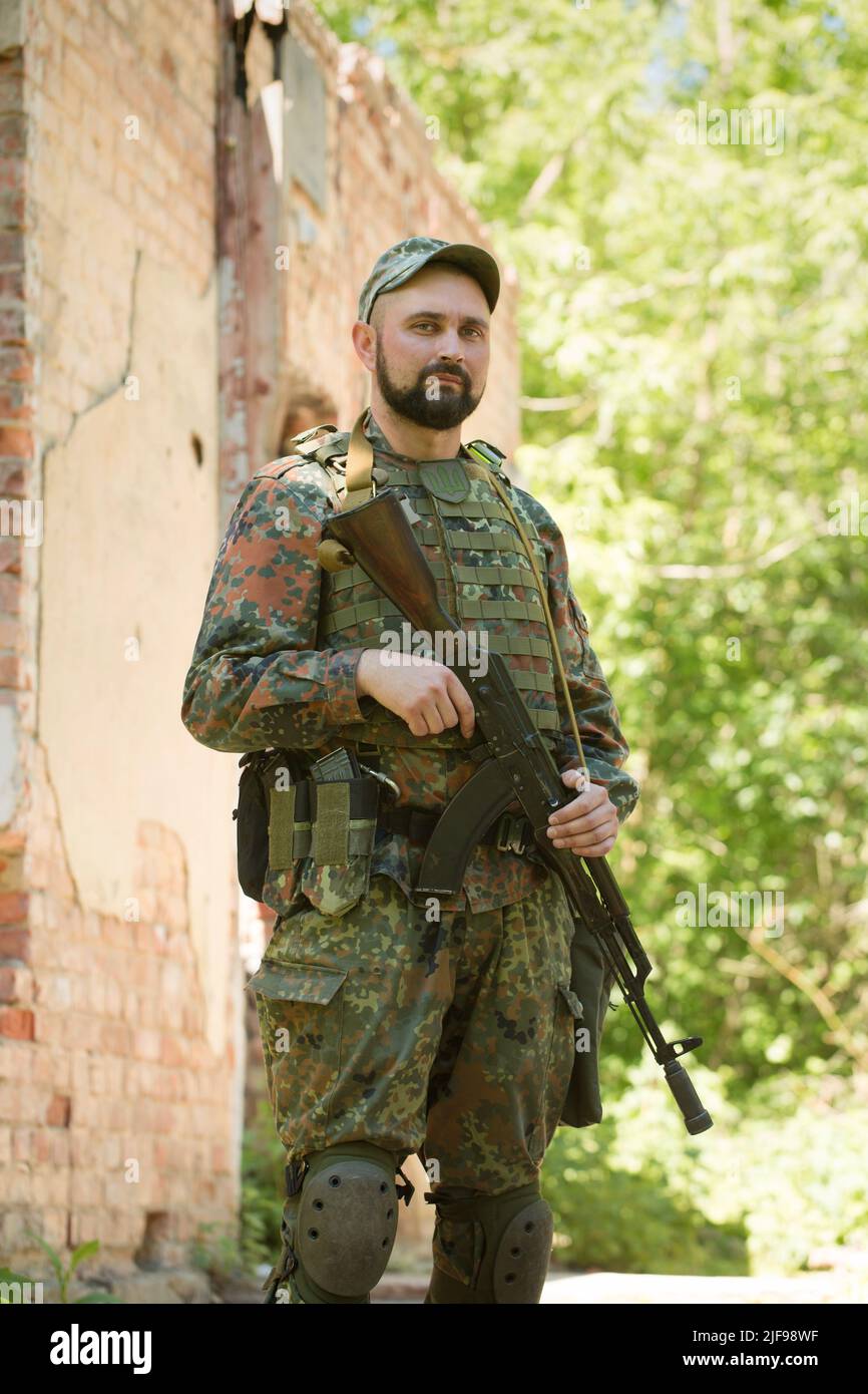 Portrait of a Ukrainian military man with a Kalashnikov assault rifle ...