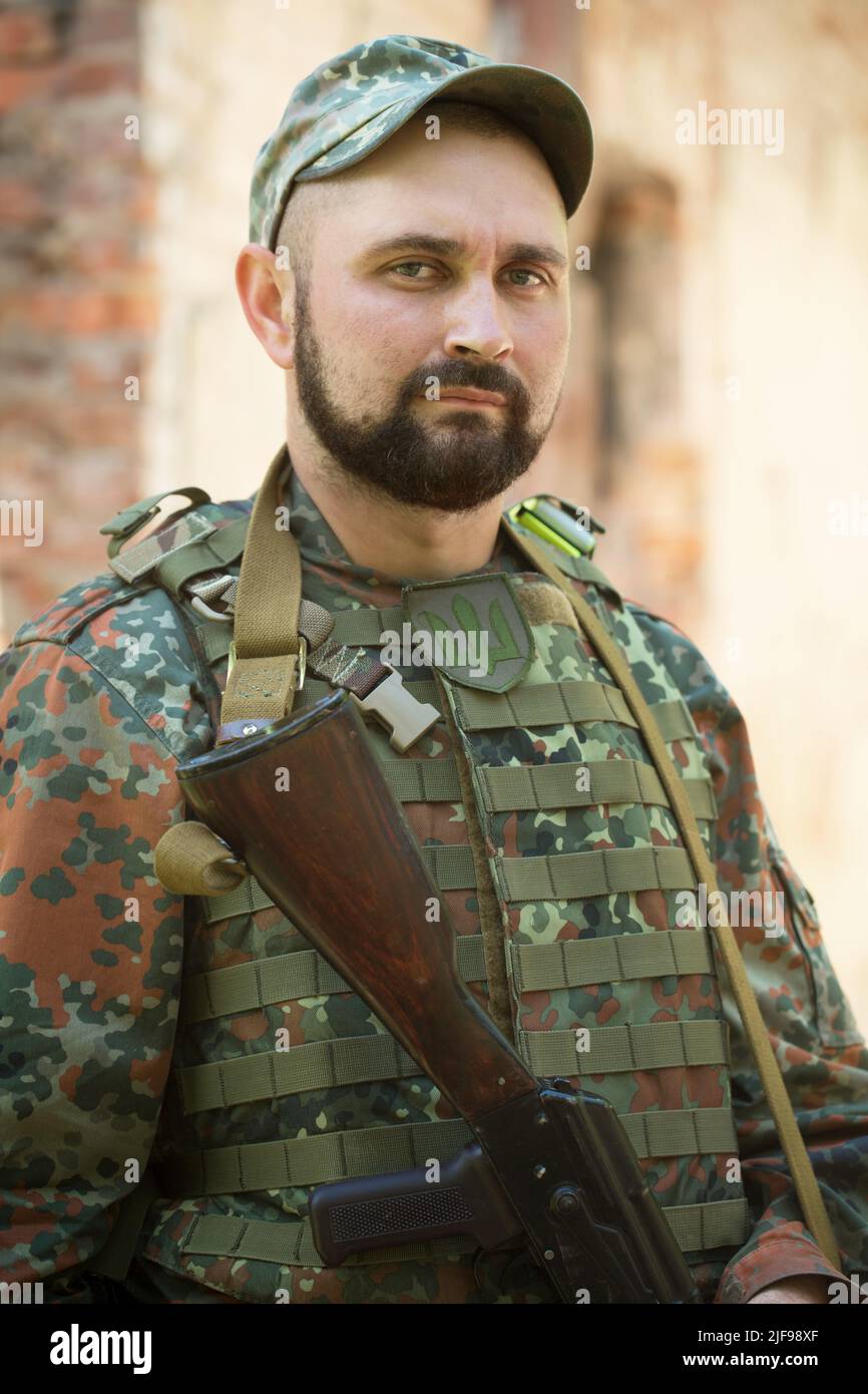 Portrait of a Ukrainian military man with a Kalashnikov assault rifle ...