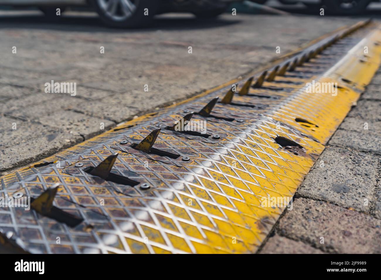 Metal road blockade that slashes the tires of a vehicle. Outdoor shot ...