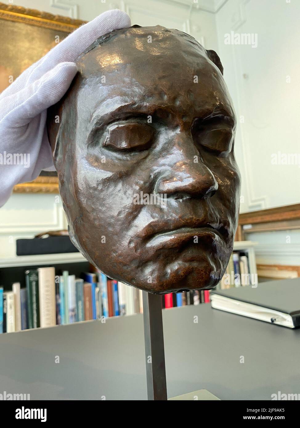London, UK. 30th June, 2022. A woman displays a bronze cast of a living ...