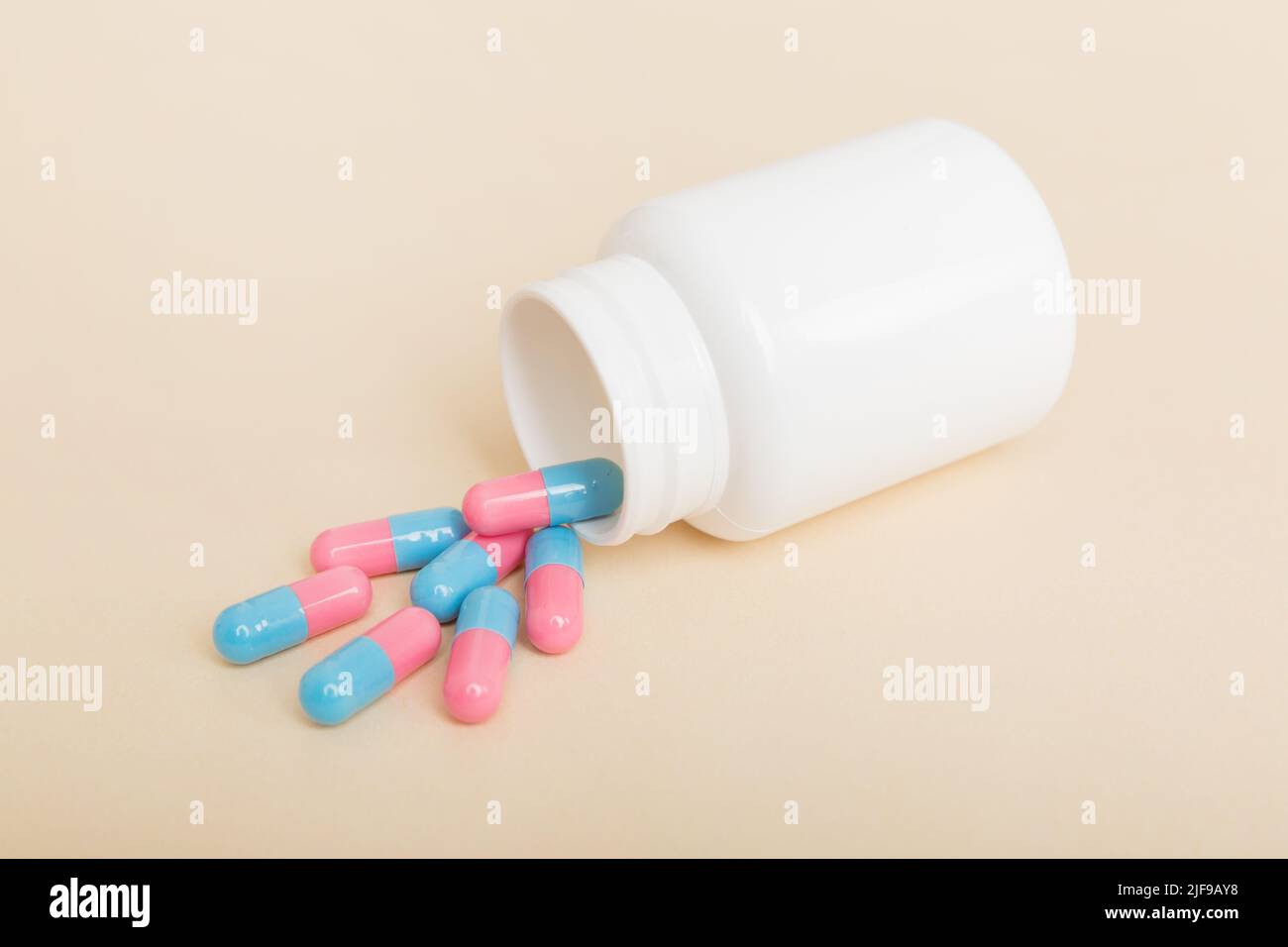 different drugs and health supplement pills poured from a medicine ...