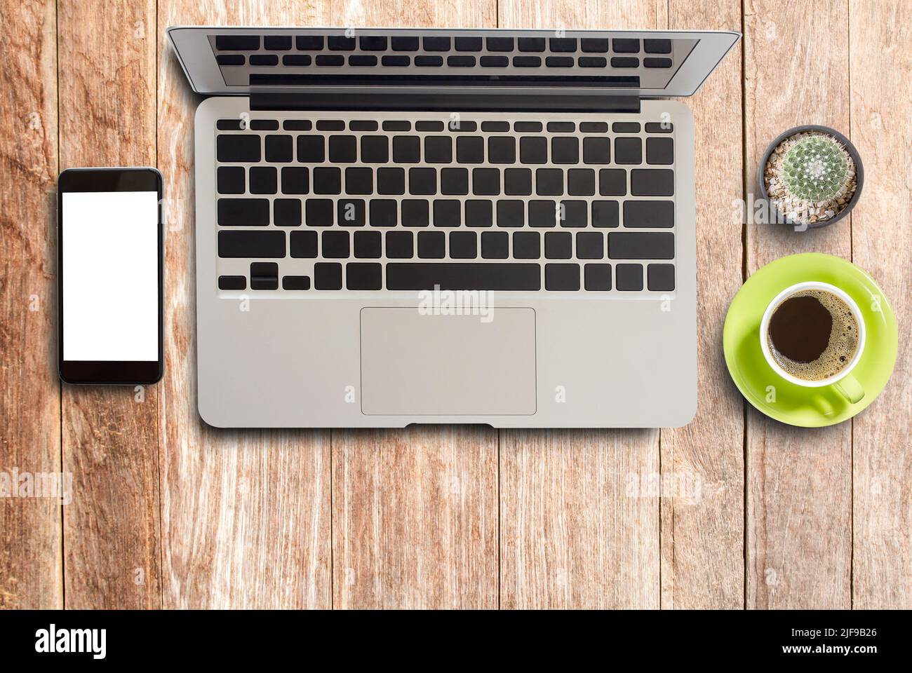 Modern wood office desk table with laptop,smart phone,cup of coffee and ...